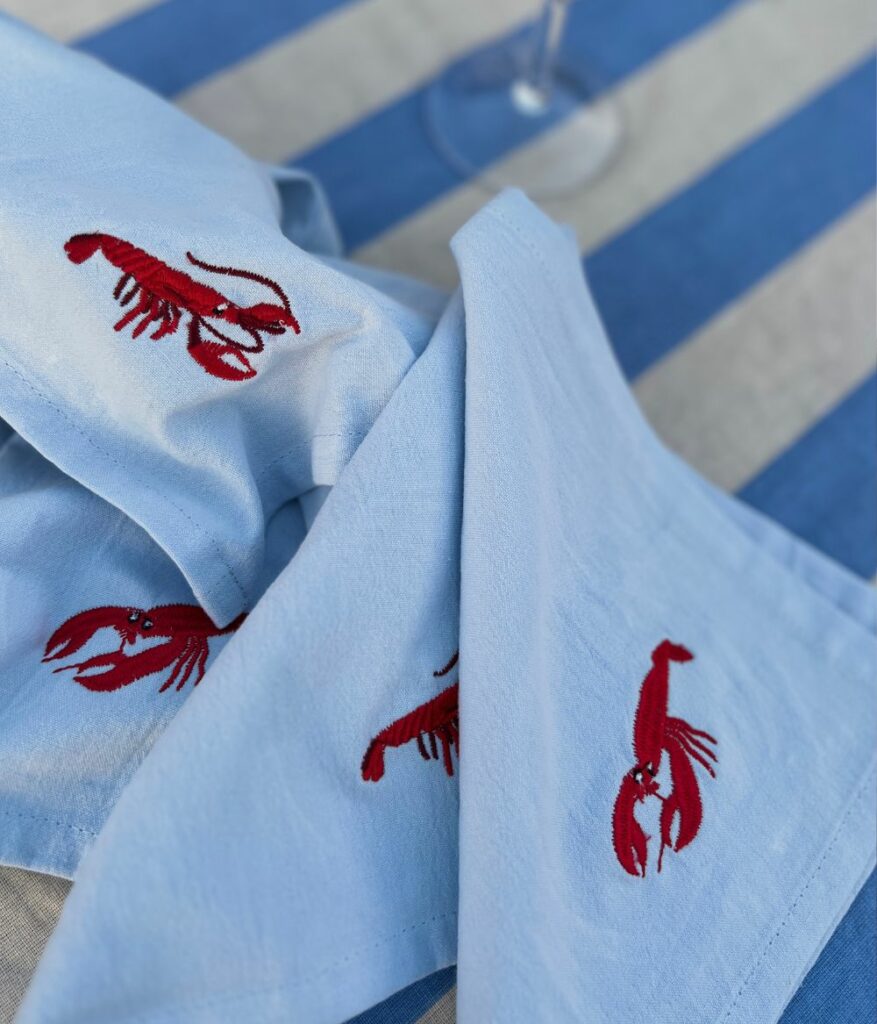 Light blue napkin with crayfish embroideries