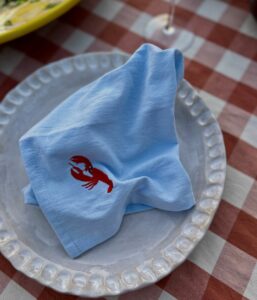 Light blue napkin with crayfish embroideries