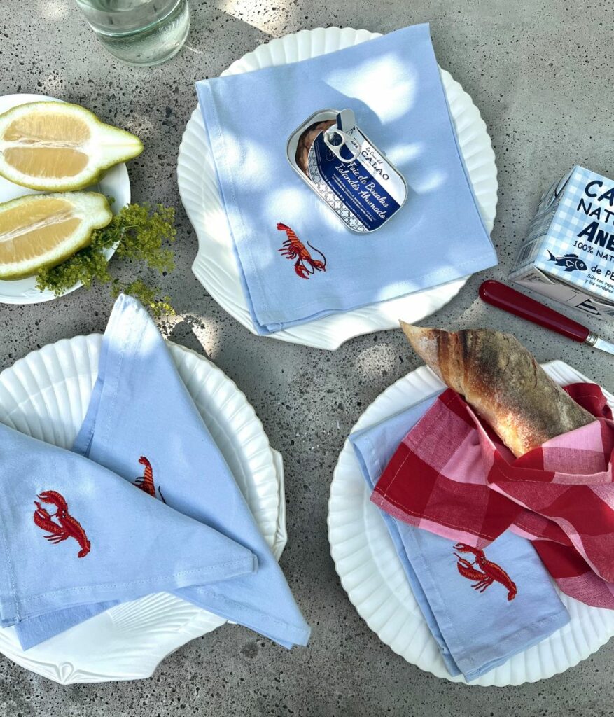 Light blue napkin with crayfish embroideries
